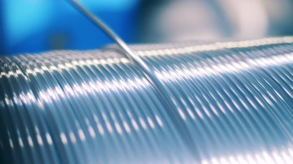 Shiny Silver Electrical Wire Unwinding From a Spool, Stock Footage
