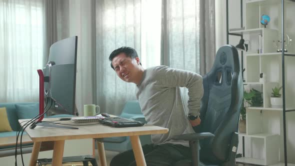 Asian Man Having Backache While Using Desktop Computer For Working At ...