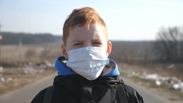 Portrait of Little Boy with Medical Face Mask Standing Outdoor. Sad ...