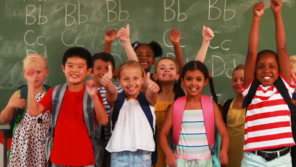 Smiling kids showing thumbs up in classroom, Stock Footage | VideoHive