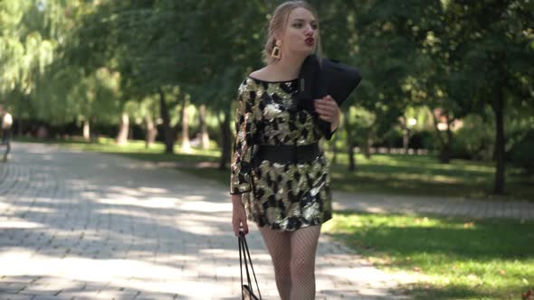 Angry Exhausted Female Young Partygoer Walking in Sunny Summer Park in ...