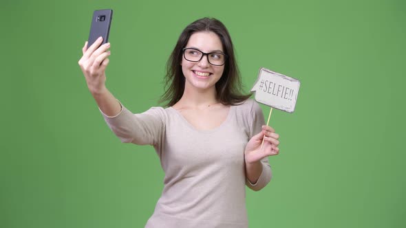 Young Happy Beautiful Woman Taking Selfie While Holding Paper Sign ...