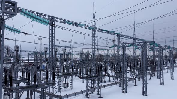 Aerial view of a high voltage electrical substation in winter season ...