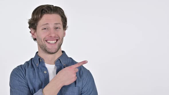 Young Man Pointing at Product Talking on White Background, Stock Footage