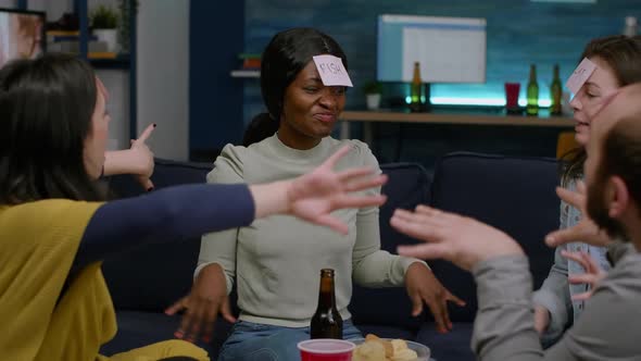 Group of Friends with Sticky Notes Playing Guess Who Game, Stock Footage
