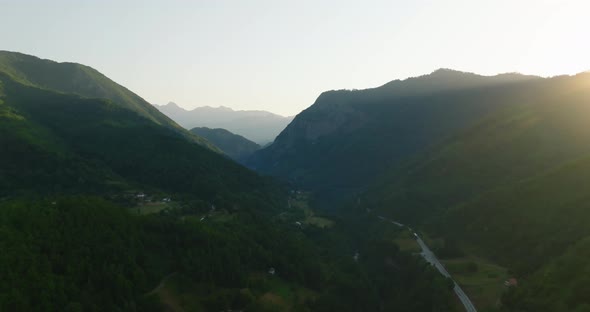 aerial view of valley between two mountains with sun flares, Stock Footage