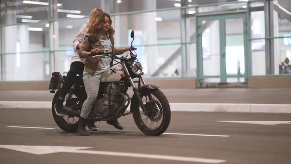 Two Beautiful Young Women Riding a Motorcycle at Night on City Street ...