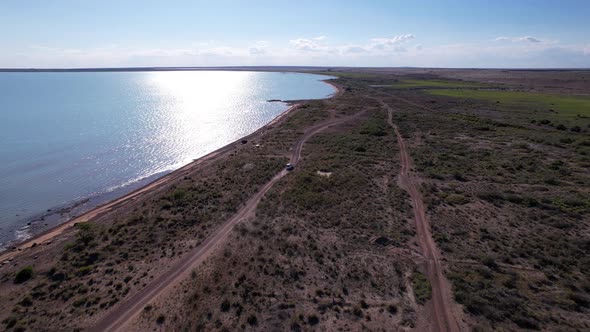 A White Car Drives Along Beach of Lake Balkhash, Stock Footage | VideoHive