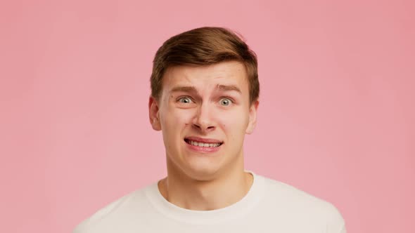 Disgusted Millennial Guy Frowning Posing Over Pink Background Studio ...