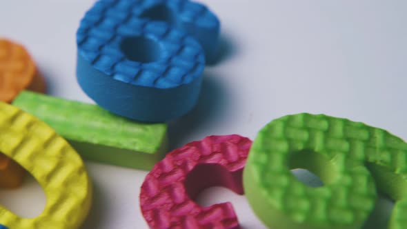 Heap of Foam Rubber Numbers Lies on Clean White Background, Stock Footage