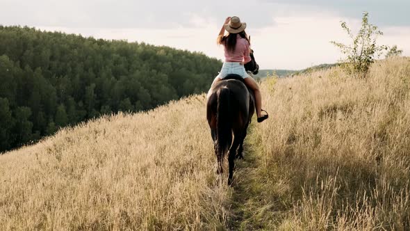 Beautiful Girl Riding a Horse in Countryside. Female Rider Rides a ...
