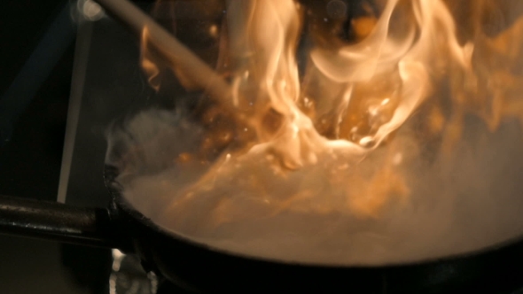 Chef Cooking With Fire In Frying Pan.Professional Chef In a Commercial ...