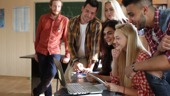 Students Excited Watching Video Using Tablet Computer And Laptop ...