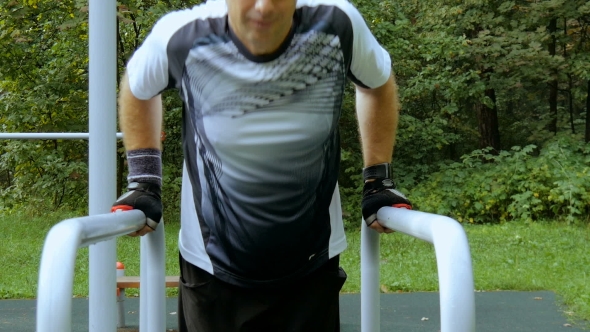 A Man Does Push-ups On Parallel Bars, Stock Footage | VideoHive