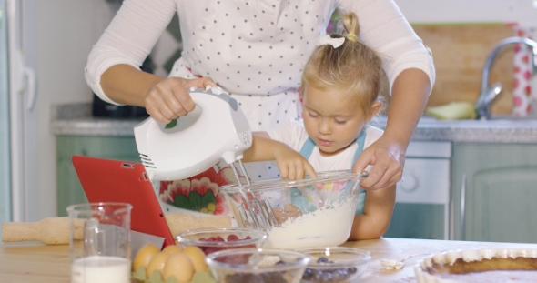 Cute Little Kitchen Helper Helping Her Mum, Stock Footage | VideoHive