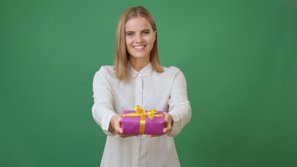Happy Beautiful Woman Giving a Gift and Smiling, Stock Footage | VideoHive