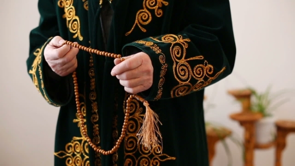 An Old Mullah in National Dress Praying With Rosary Beads in Hands ...