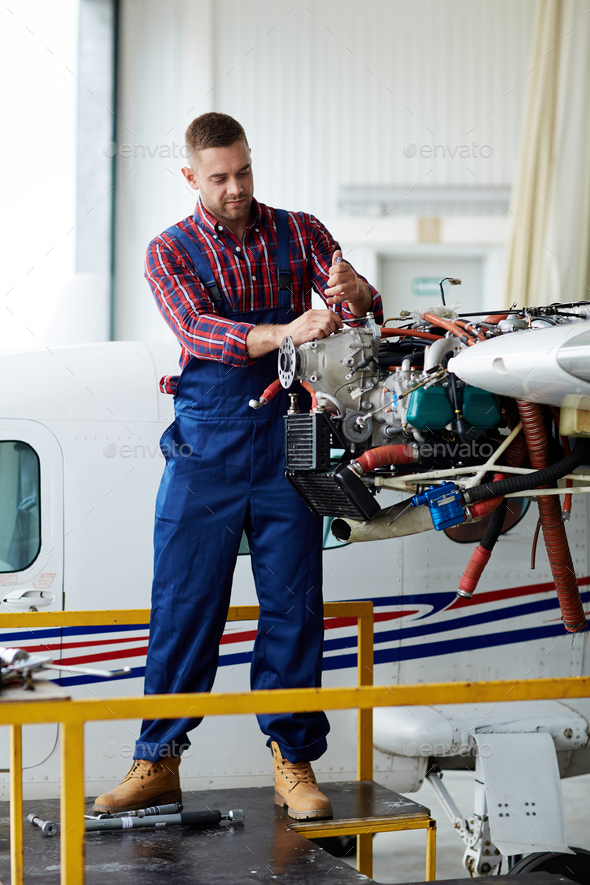 Working with engine Stock Photo by Pressmaster | PhotoDune