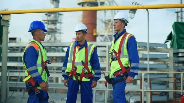 Three Workers In Production Plant As Team Discussing, Industrial Scene ...