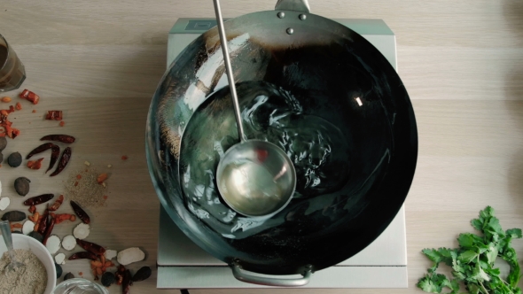 Chef Stirs Cooking Oil In Wok An Commercial Kitchen, Stock Footage