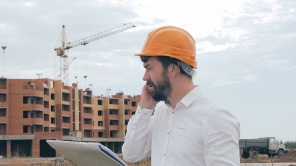 Architect Talking On Cell Phone On a Construction Site., Stock Footage