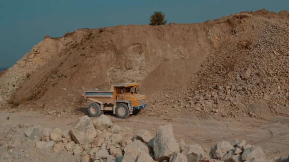 Mining Truck is Driving an Iron Ore Mine Loaded with Ore, Stock Footage