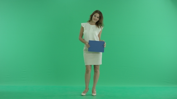 Girl Showing a Blue Screen On a Green Background, Stock Footage | VideoHive