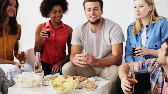 Friends With Drinks And Snacks Talking At Home, Stock Footage | VideoHive