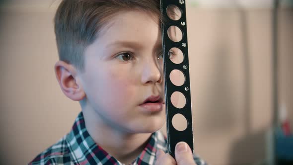 A Little Boy Having a Treatment in Eye Clinic - a Doctor Checking an ...