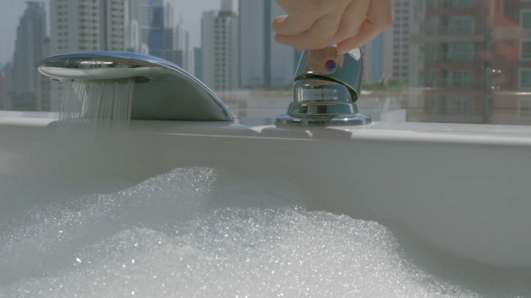 Woman Pouring Water Into The Bathtub With Foam, Stock Footage | VideoHive