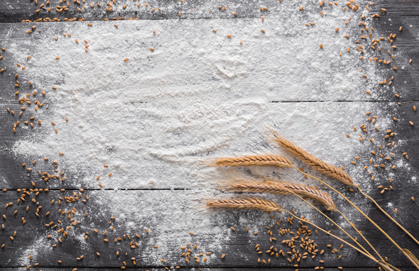 Baking concept on wood background, sprinkled flour with copy space ...