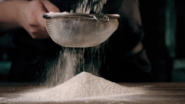 Chief's Hands Sifting Flour Through a Sieve For Baking, Stock Footage