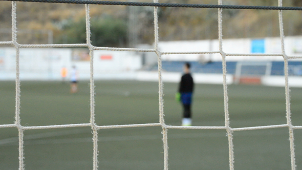 Children Goalkeeper in a Football Game Behind the Goal, Stock Footage