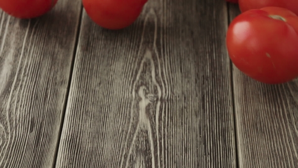 Tomatoes Roll Over The Screen In On Wooden Background, Stock Footage