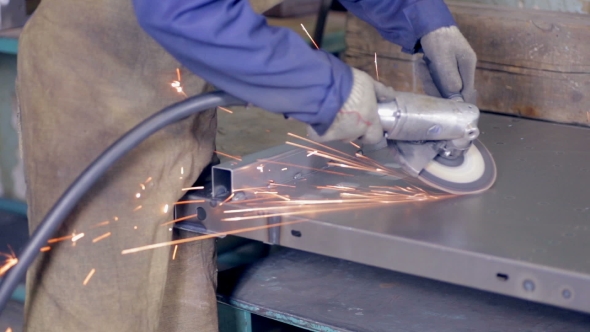Worker Using Industrial Grinder Operating With Metal At a Metal ...