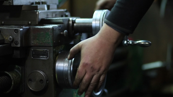 Worker Controls Adjustment Wheel Of Lathe Machine, Stock Footage ...
