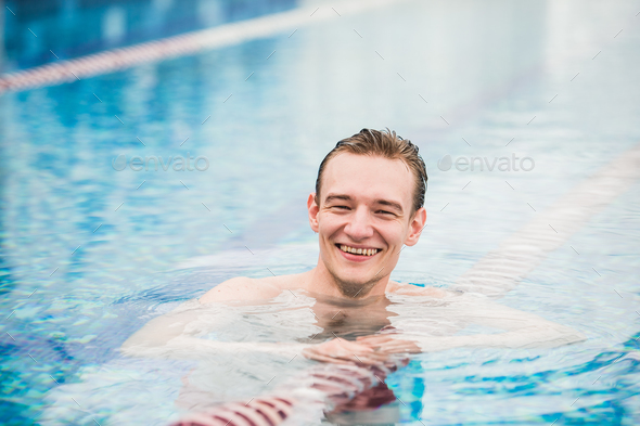 Handsome athletic male posing in a swinning pool Stock Photo by ...