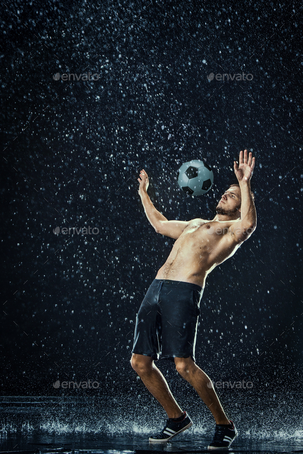 Water drops around football player Stock Photo by master1305 | PhotoDune