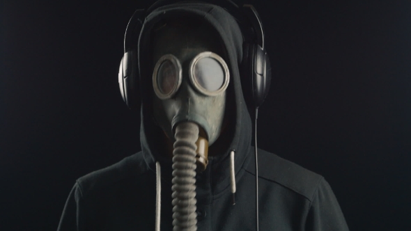 Man Listens To Music With Headphones And Dance With Gas Mask Covering ...