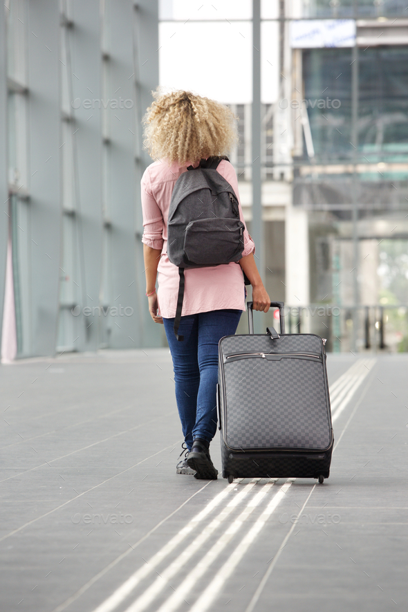 Woman Walking Away With Suitcase