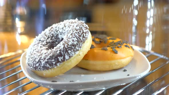 Appetizing donuts rotation on showcase in a coffee shop., Stock Footage