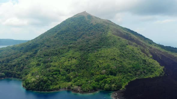 Aerial: flying over Banda Islands active volcano Gunung Api lava flows ...