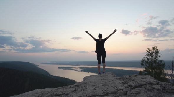 Silhouette Of Happy Girl Raised Her Hands Up To The Sun, Standing On ...