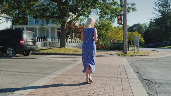 The Woman Crosses the Road on a Pedestrian Crossing To the Permissive ...