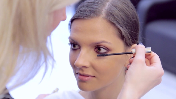 Make-up Artist Coats Model's Eyelashes With Mascara, Stock Footage