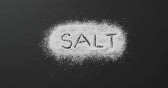 Animation of salt text written in salt on black background, Stock Footage