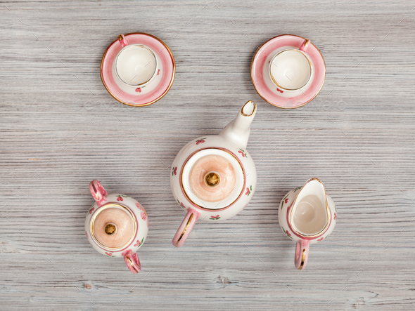 pink porcelain tea set on gray brown table Stock Photo by vvoennyy