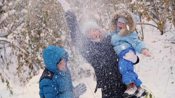 Girl And Child Throwing Snow Over Himself And Enjoys It In The Winter ...