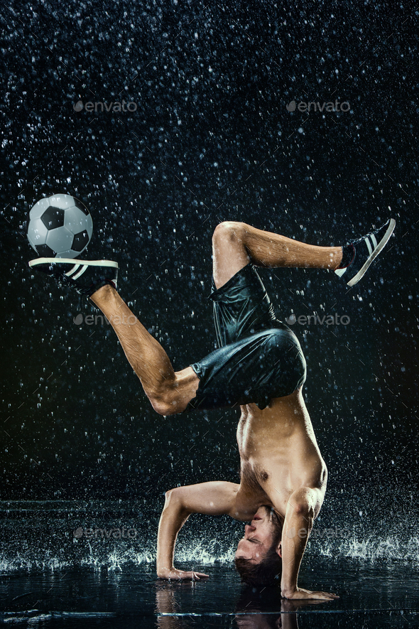Water drops around football player Stock Photo by master1305 | PhotoDune