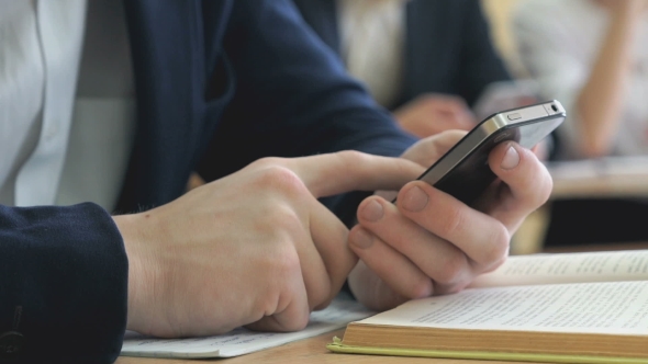 Boy Writes The Text Using a Mobile Phone Indoors, Stock Footage | VideoHive